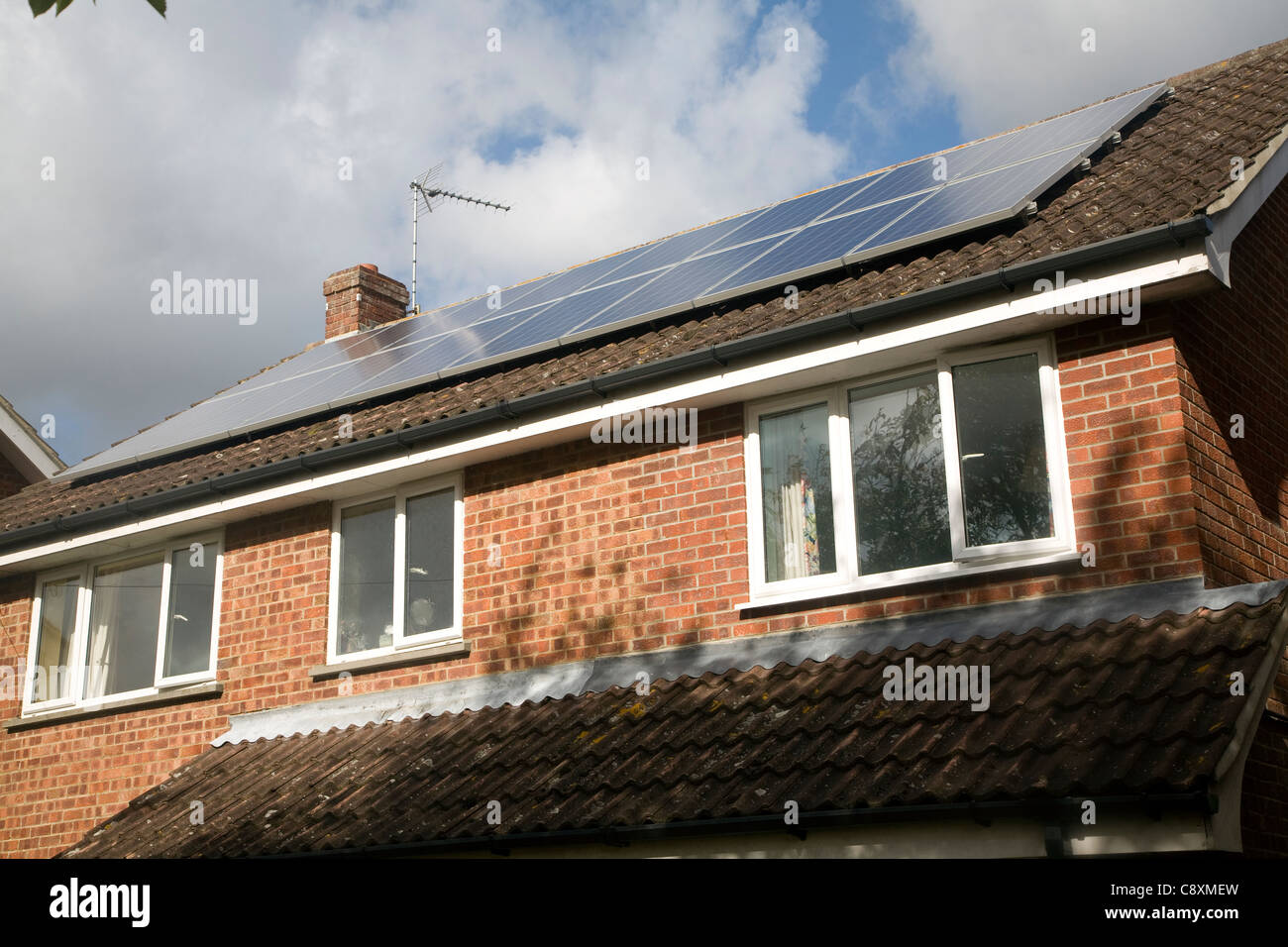 Large array of solar panels on domestic house roof Stock Photo - Alamy