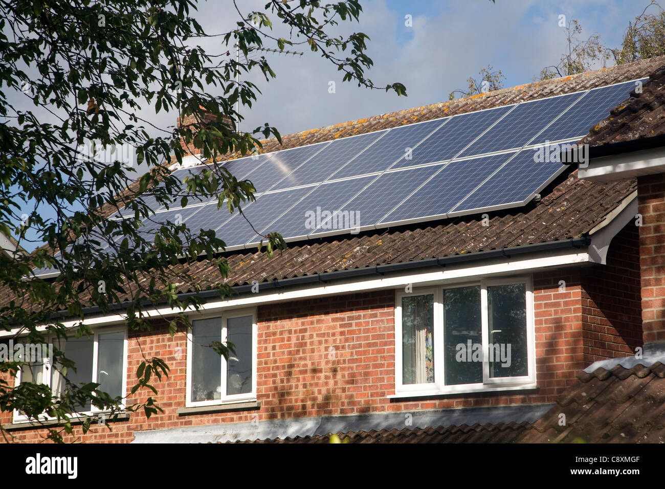 Large array of solar panels on domestic house roof Stock Photo - Alamy
