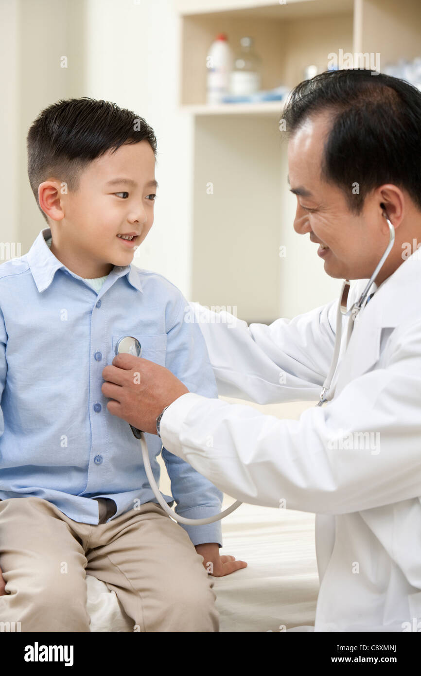 Boy being examining doctor stethoscope hi-res stock photography and ...