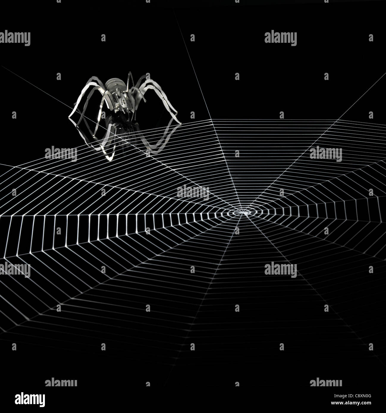 a simplified spider made of metal and a artificial spiderweb. Red ...