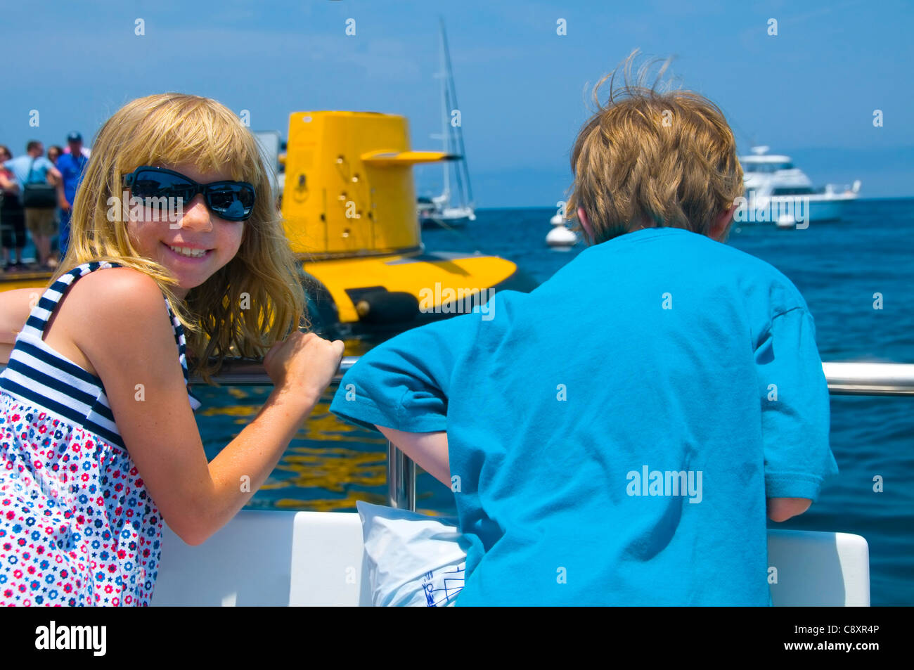 Two Kids at the rail of an Excursion Boat. (Busy B/G for a family ...