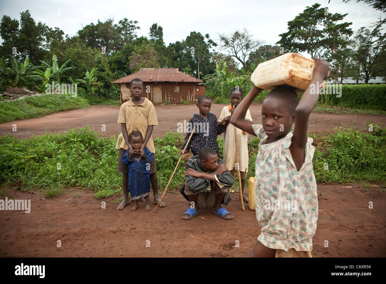 Children stand along a roadside in Nsinze Village, Namutumba District ...