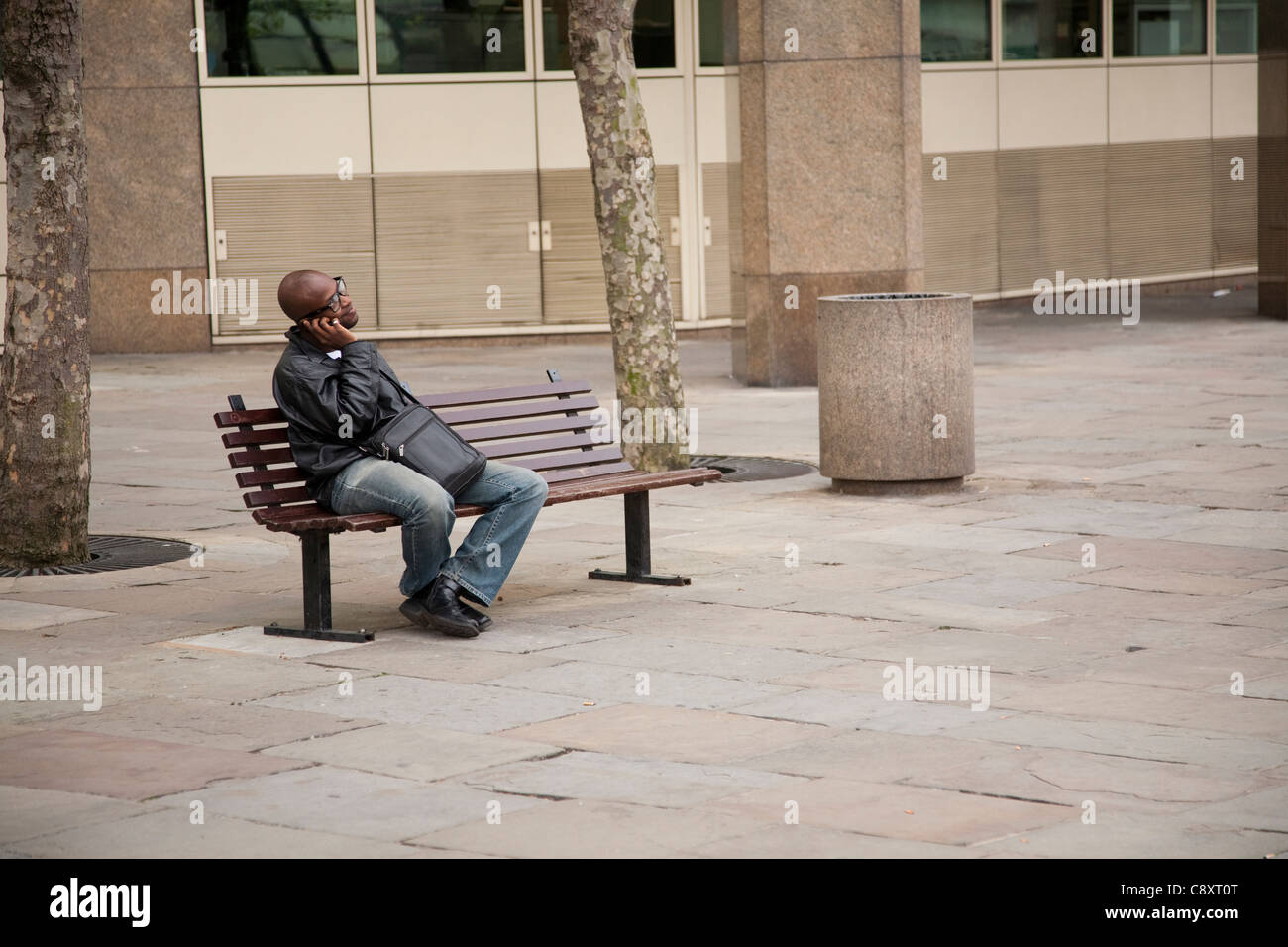 Man sitting alone having telephone conversation Stock Photo - Alamy