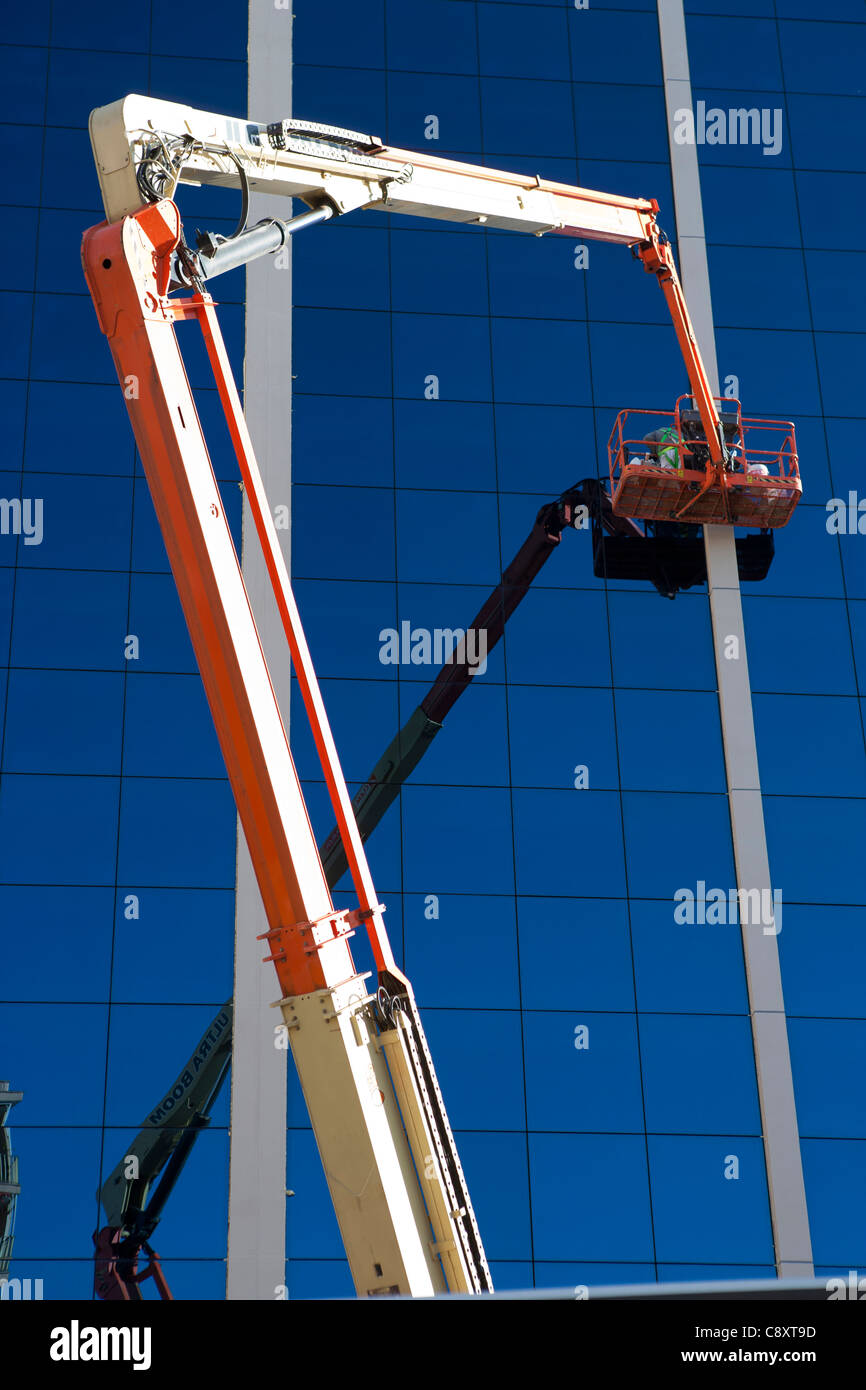 Building cleaner cleaning external glasses windows of building Mallorca ...