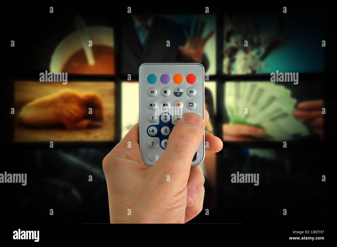 Man using a remote control and changing TV channels Stock Photo - Alamy