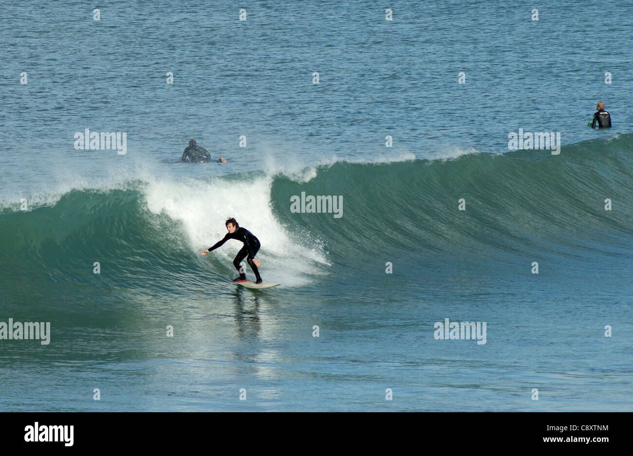 A surfer surfing a wave in Newquay, Cornwall UK Stock Photo - Alamy