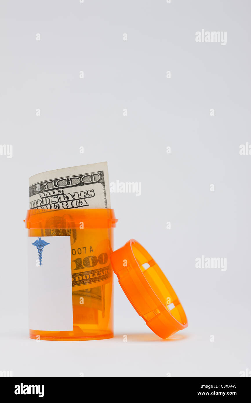 One hundred dollar bill inside pill container, studio shot Stock Photo ...