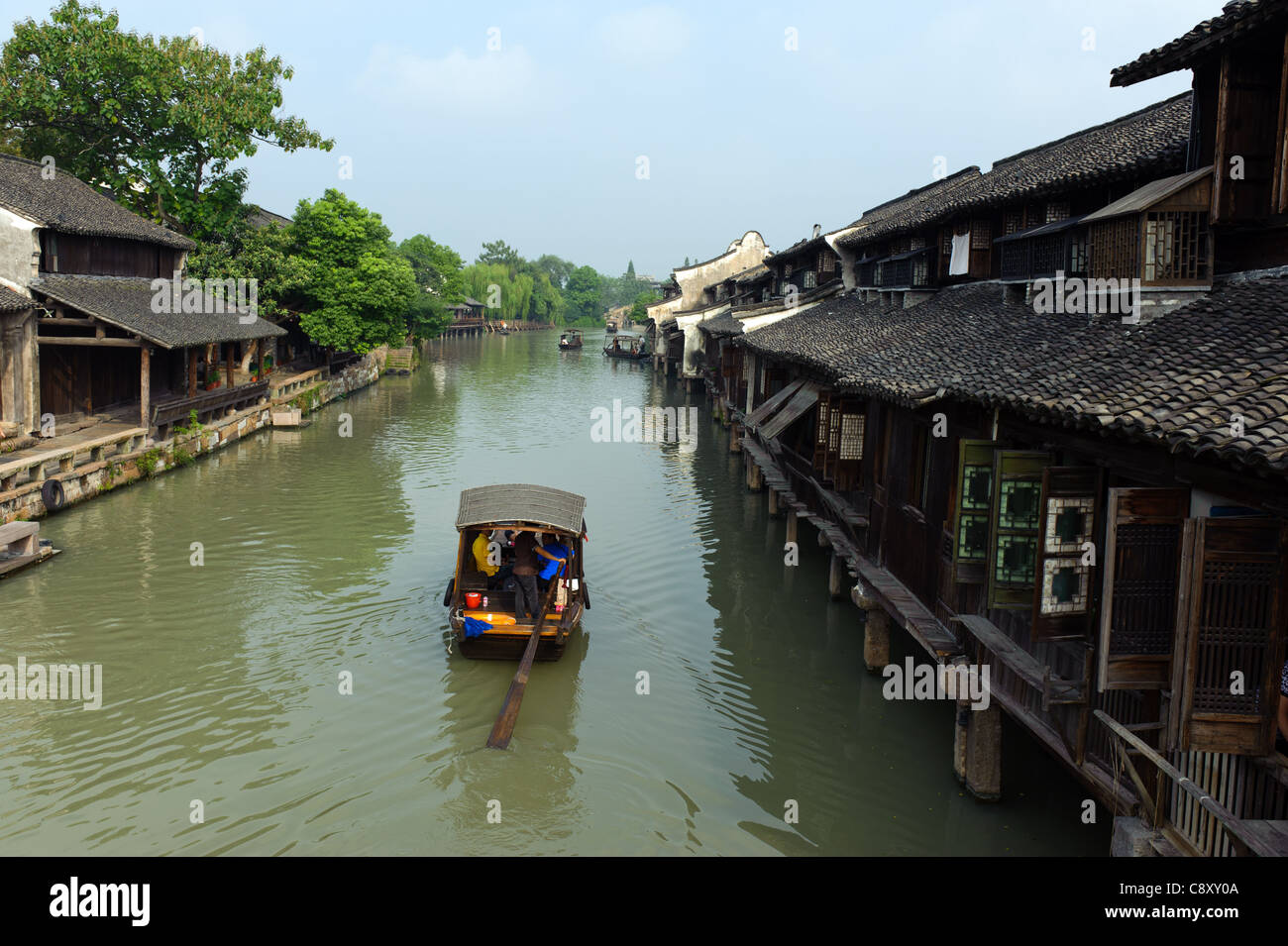 Ancient village building and boat in river in Wuzhen town, Zhejiang ...