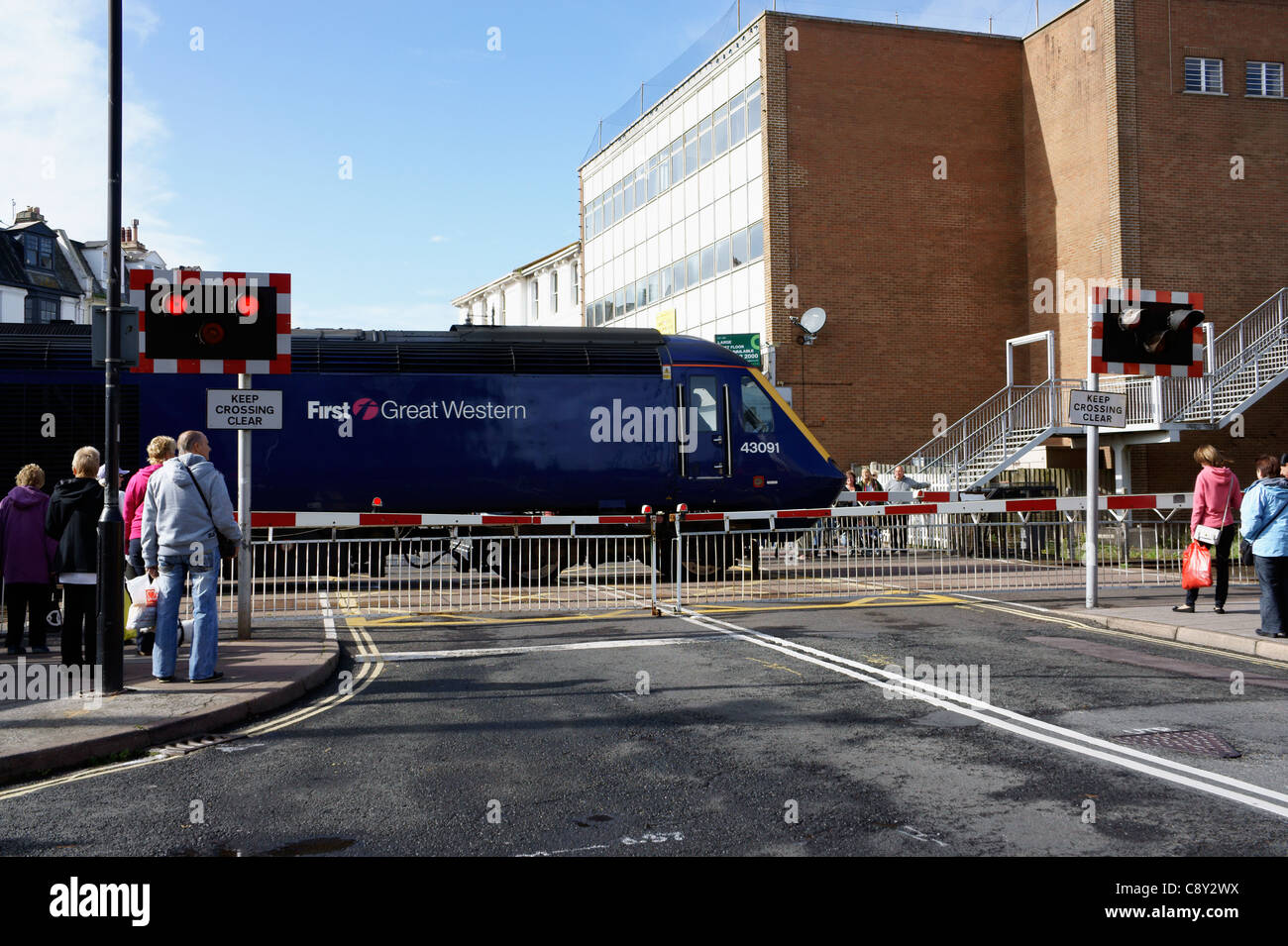 Train going through crossing at Paignton, Devon, England Stock Photo ...