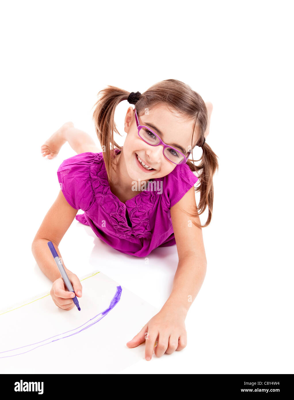 Girl lying on floor and making drawings on paper Stock Photo - Alamy