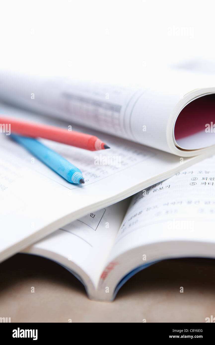 Open Books And Pencils Stock Photo - Alamy