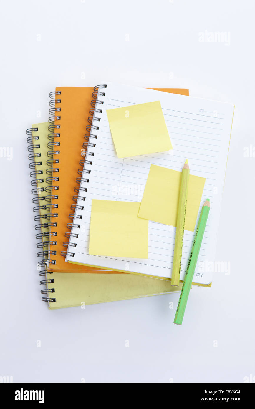 Three Note Books With Post Its And Color Pencils Stock Photo - Alamy