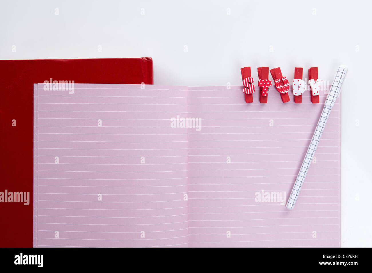 Pink Note Book With Red Alphabet Pegs Stock Photo - Alamy