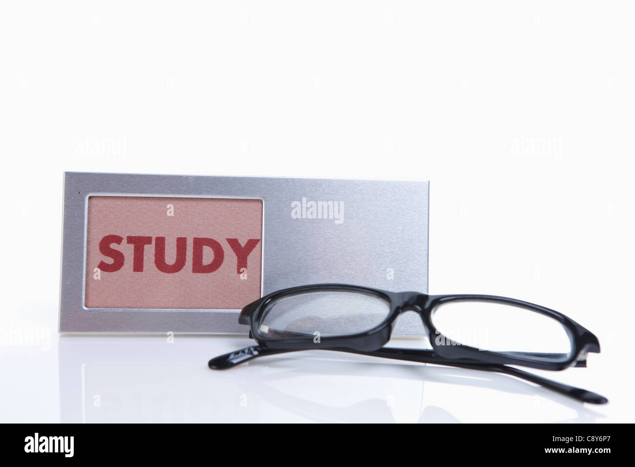 Word Study On Metal Rectangle And A Glasses Stock Photo - Alamy
