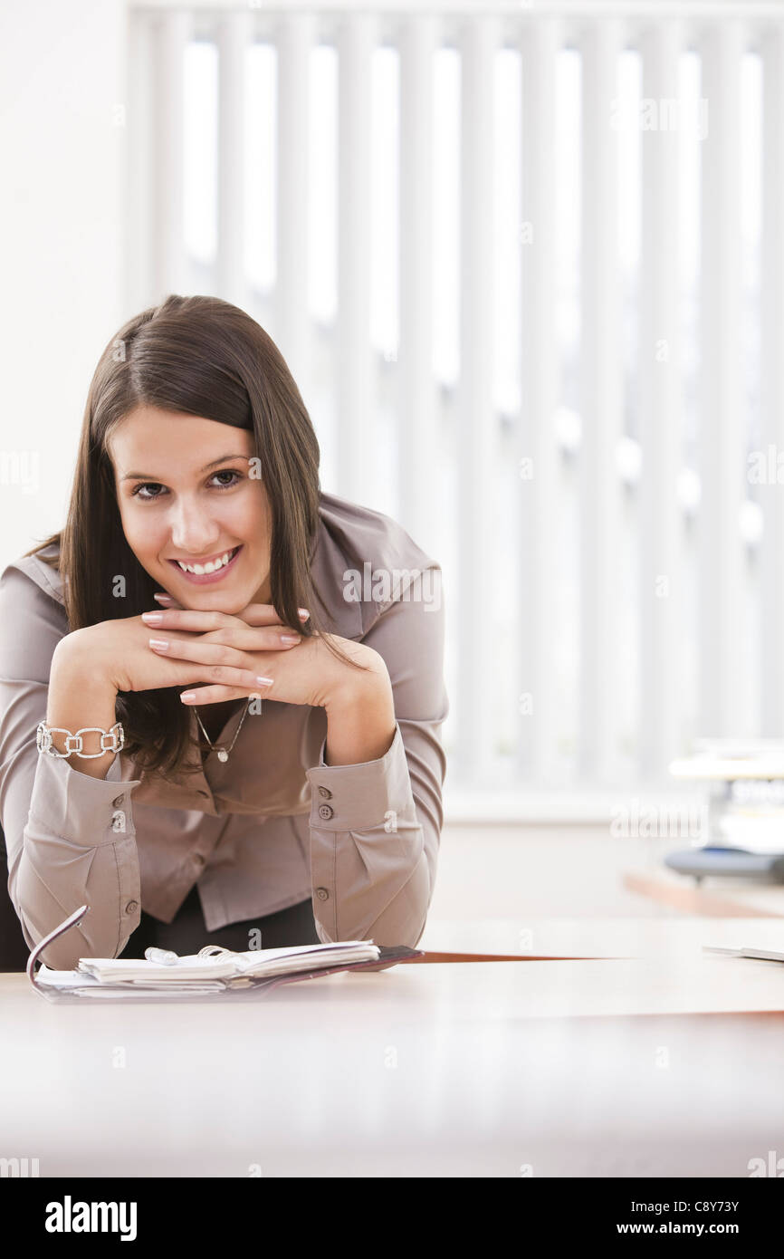 portrait of young businesswoman at desk Stock Photo - Alamy