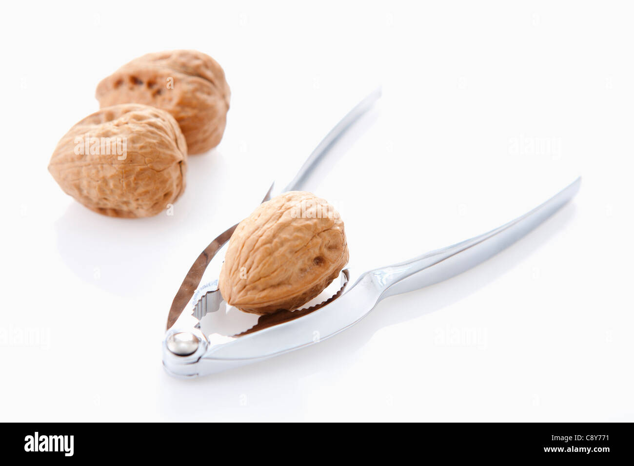 Walnuts And A Nutcracker With A Walnut Stock Photo - Alamy