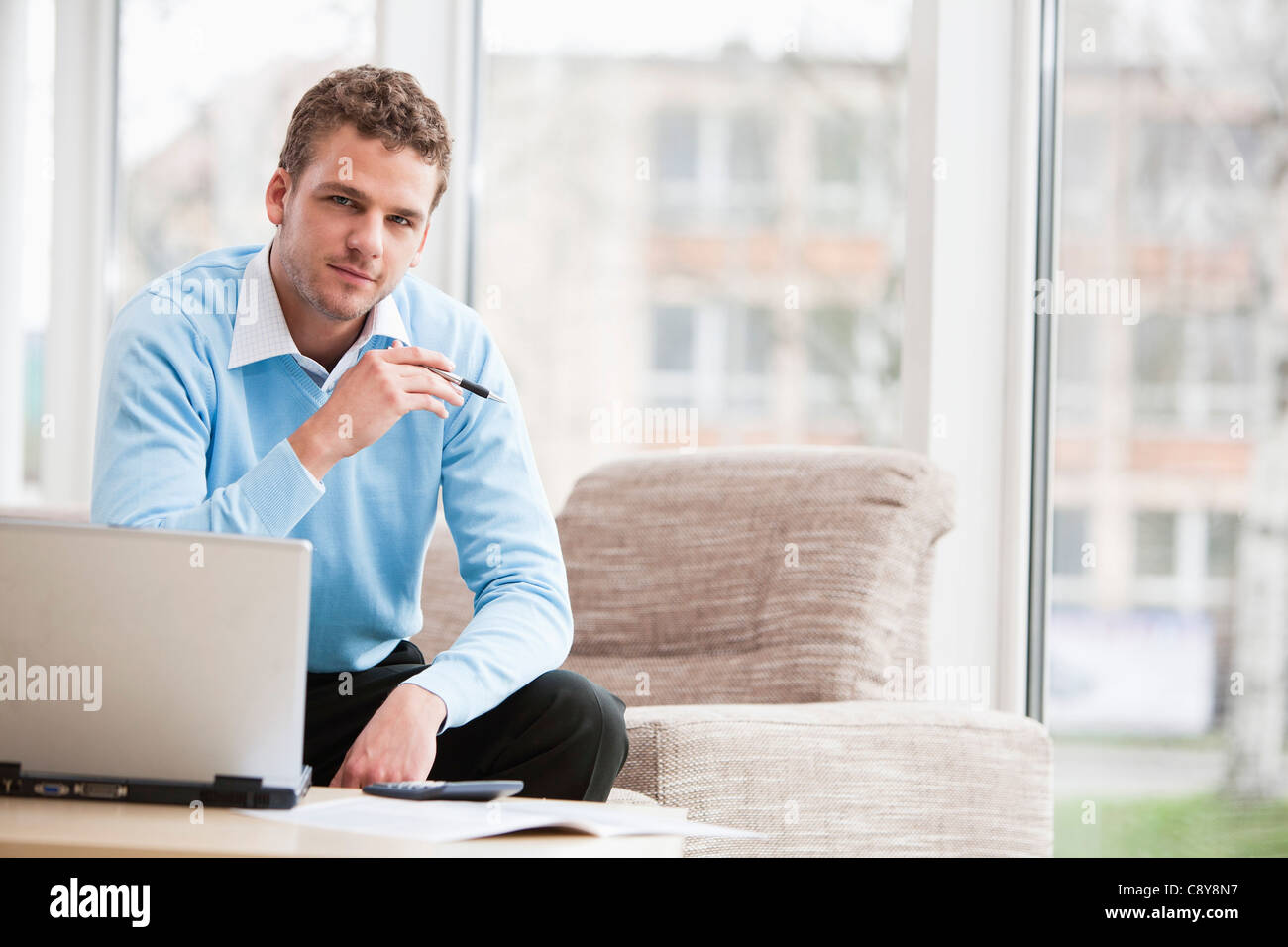 portrait of young man with laptop computer at home Stock Photo - Alamy
