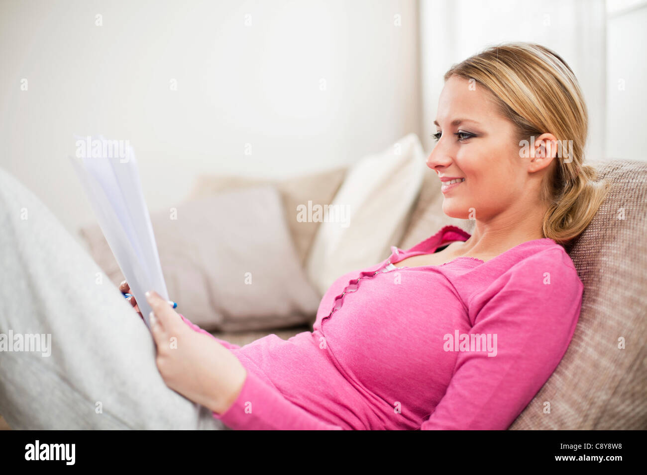 portrait of young woman at home reading letter Stock Photo - Alamy