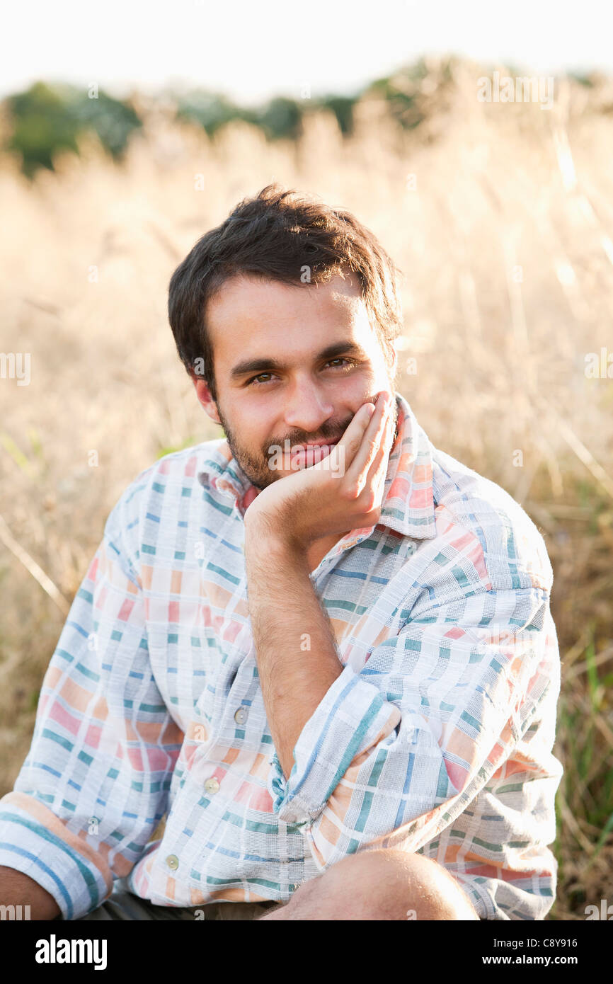 portrait of young man in front of field Stock Photo - Alamy