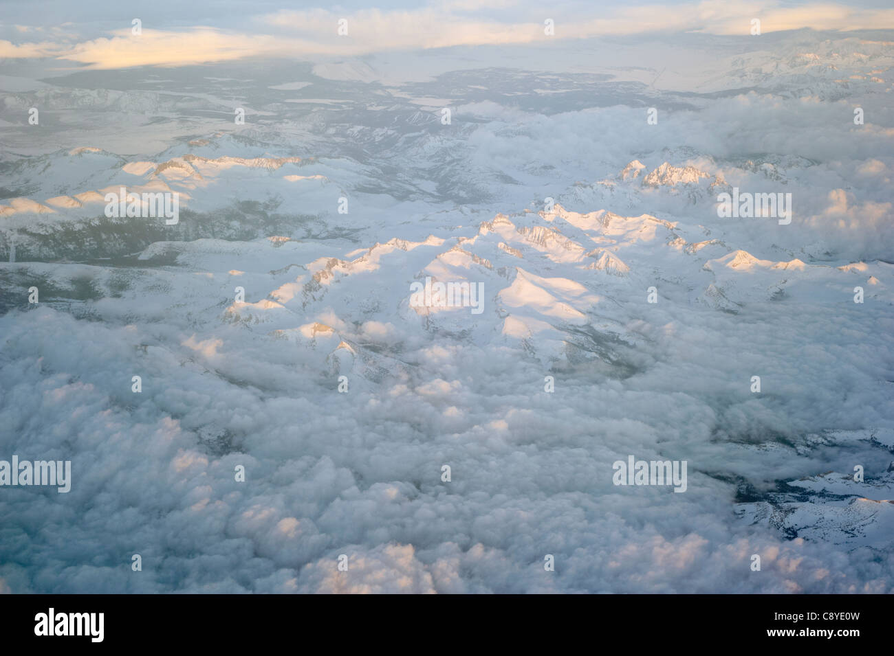 Snowy mountain range and clouds from the air Stock Photo - Alamy
