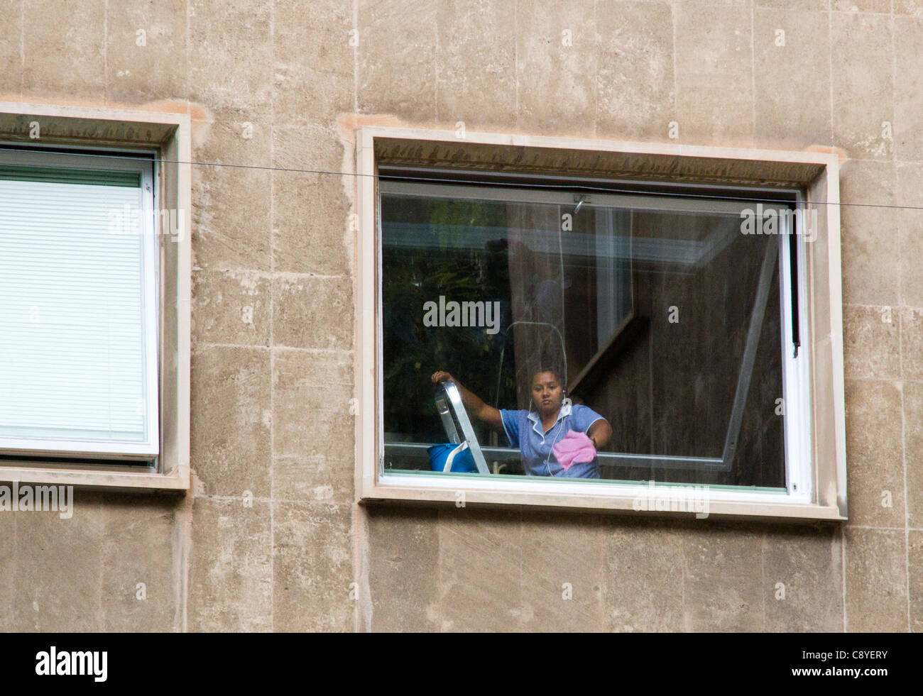 Woman worker cleaning window of office Stock Photo - Alamy