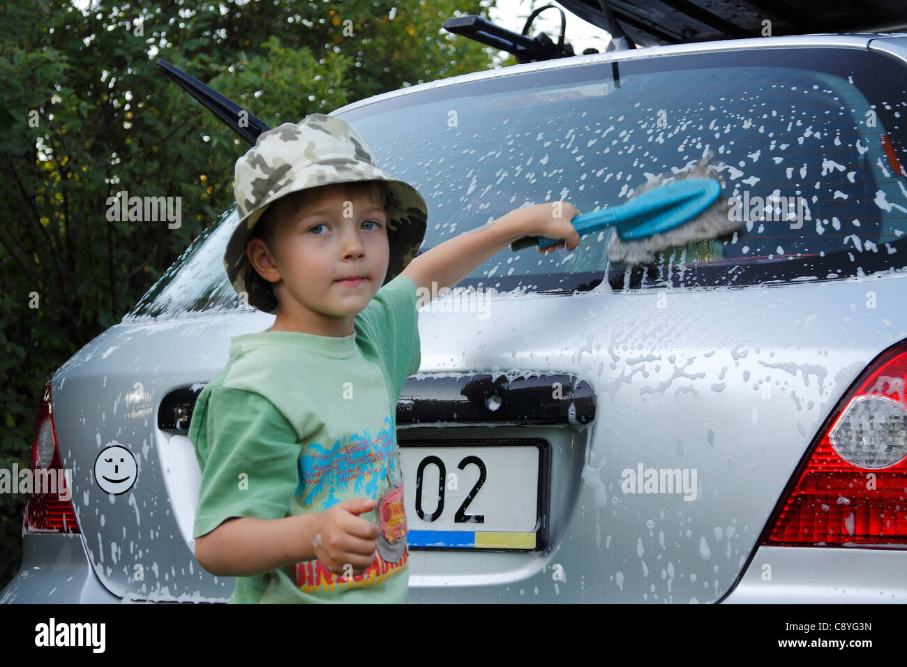 Boy washing car hi-res stock photography and images - Alamy
