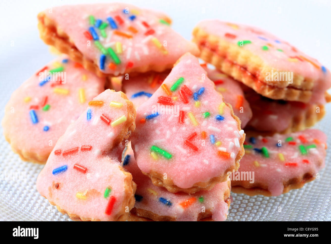 Pink frosted sugar cookies with colorful sprinkles Stock Photo - Alamy