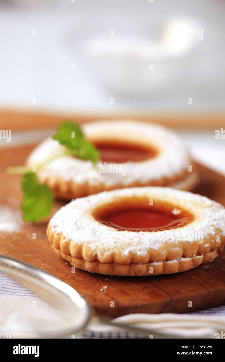 Two jam biscuits sprinkled with icing sugar Stock Photo - Alamy