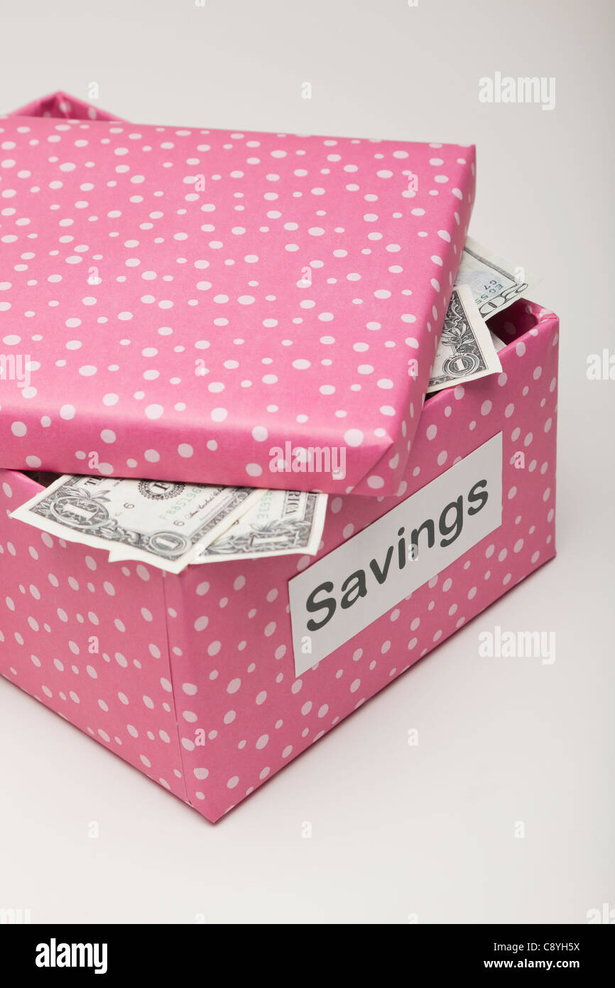 Studio shot of pink box with banknotes Stock Photo - Alamy