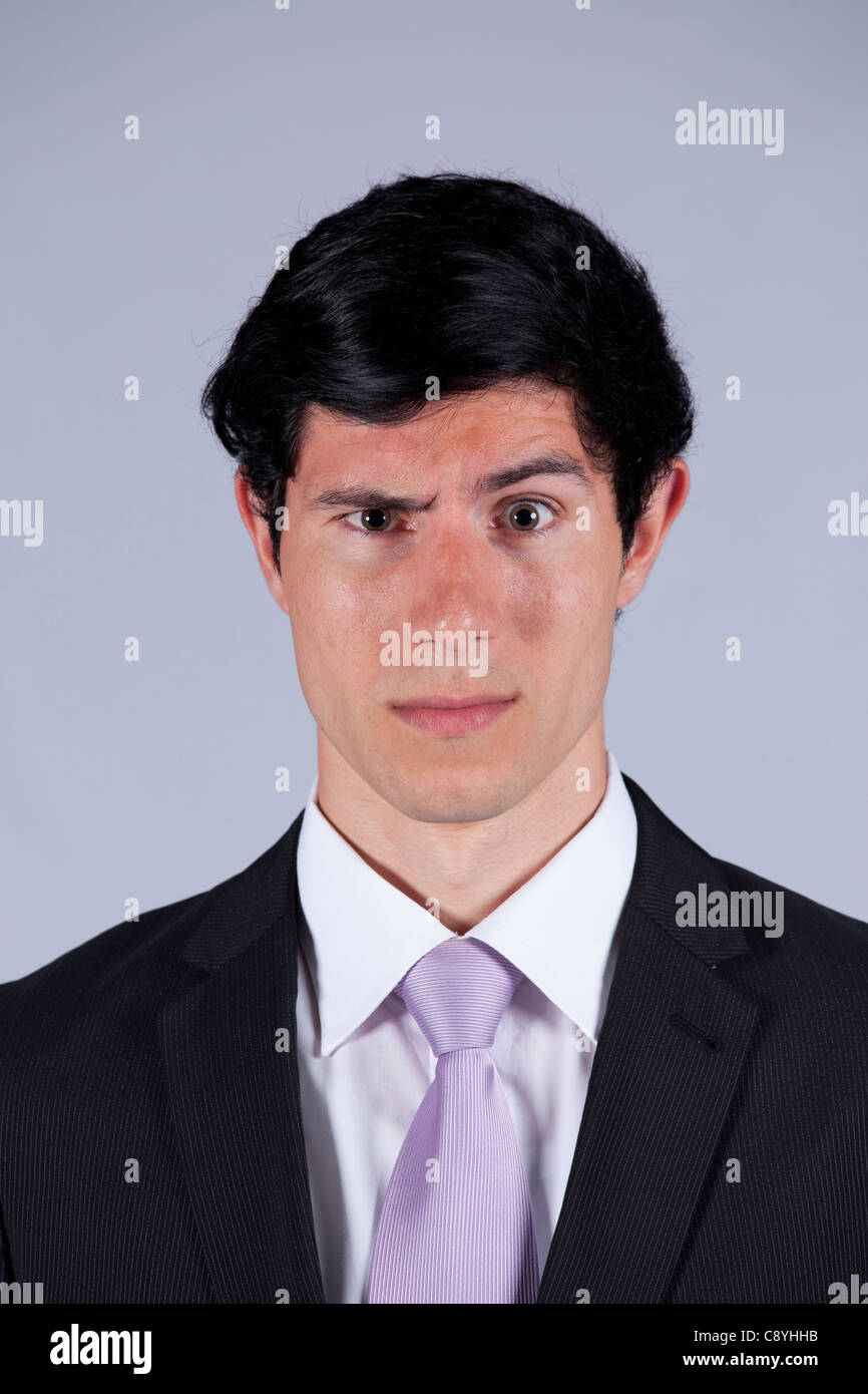 Young businessman with a suspicious look Stock Photo - Alamy