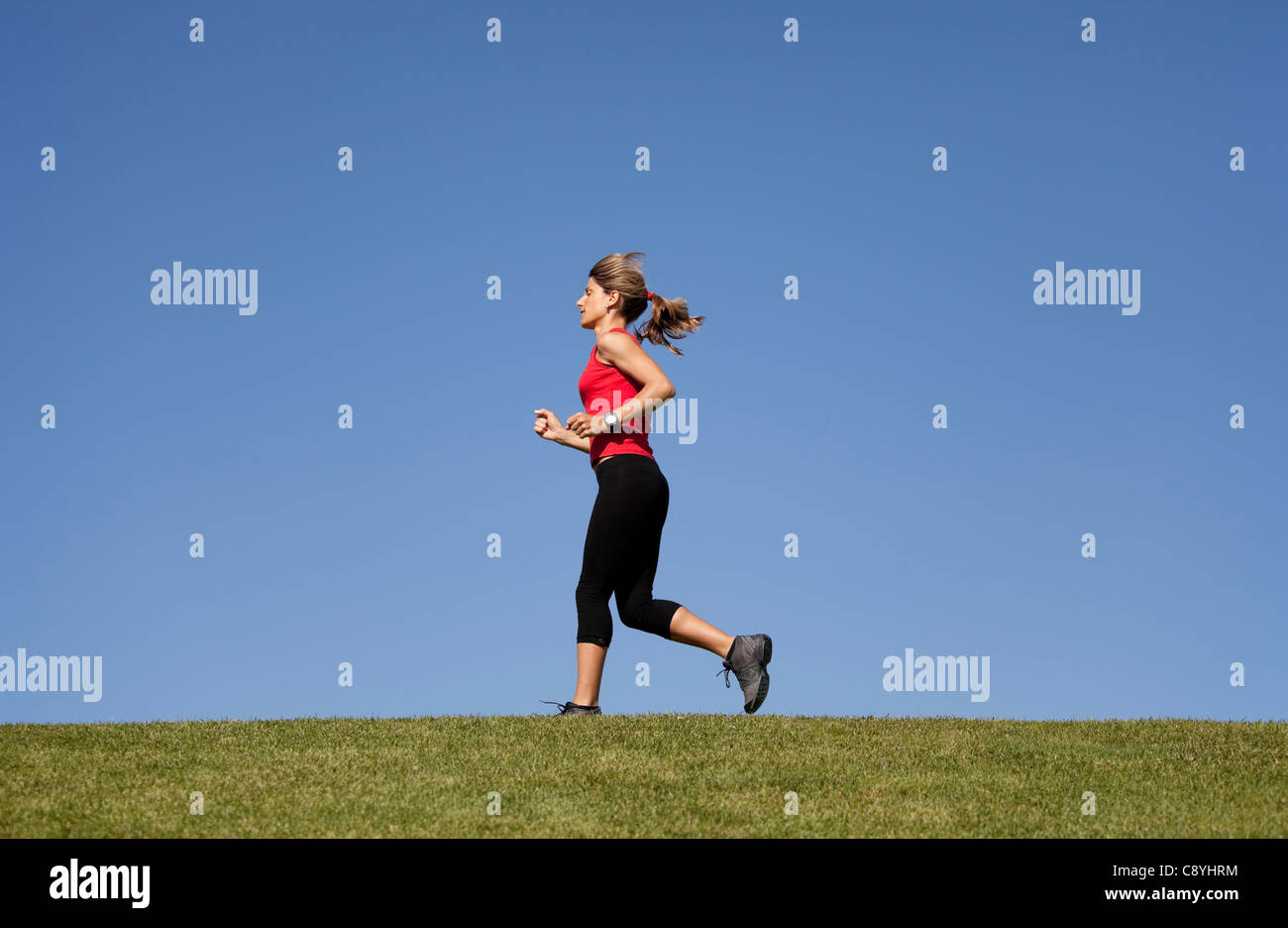 young woman running at the top of a hill Stock Photo - Alamy
