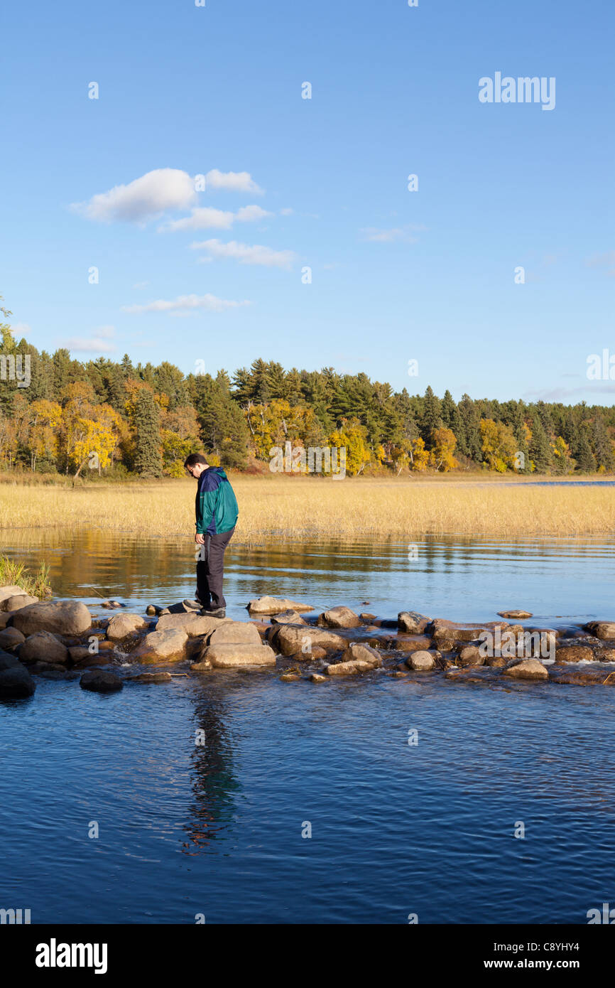 A man crosses the source of the Mississippi River on Lake Itasca in ...
