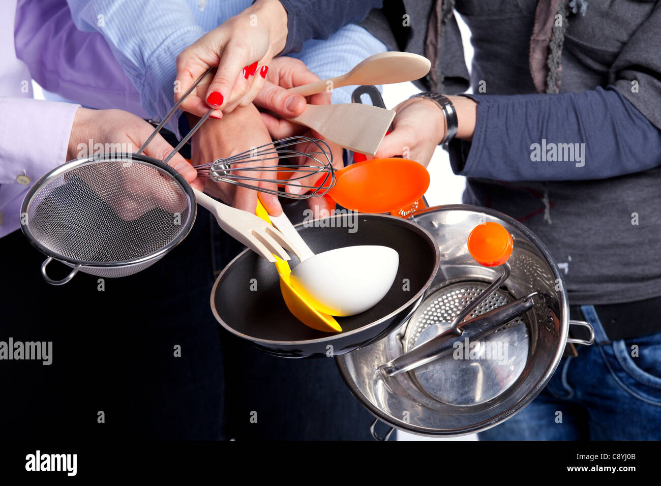 Group of people hands holding some kitchenware tools (selective focus ...