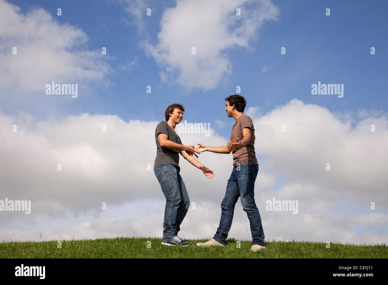 two teenager doing a special handshake Stock Photo - Alamy