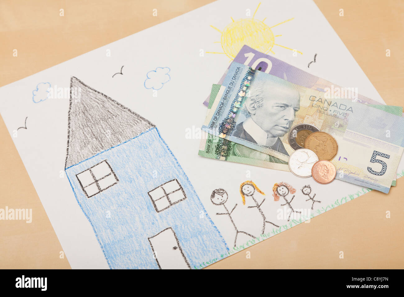 Studio shot of child's drawing of house and family and Canadian ...