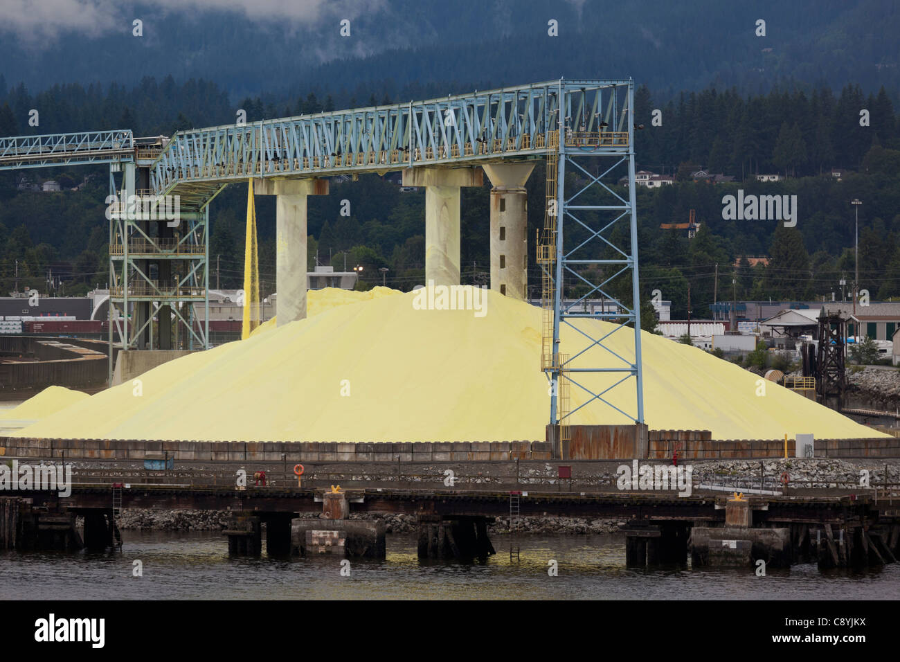A sulfur pile is processed on the waterfront in Vancouver, Canada Stock ...