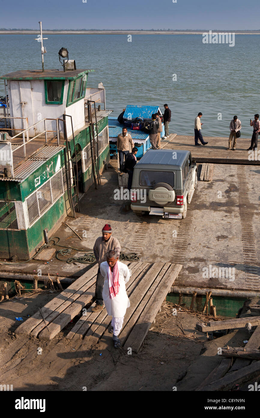 India, Assam, Jorhat, car driving onto small ferry boat crossing ...