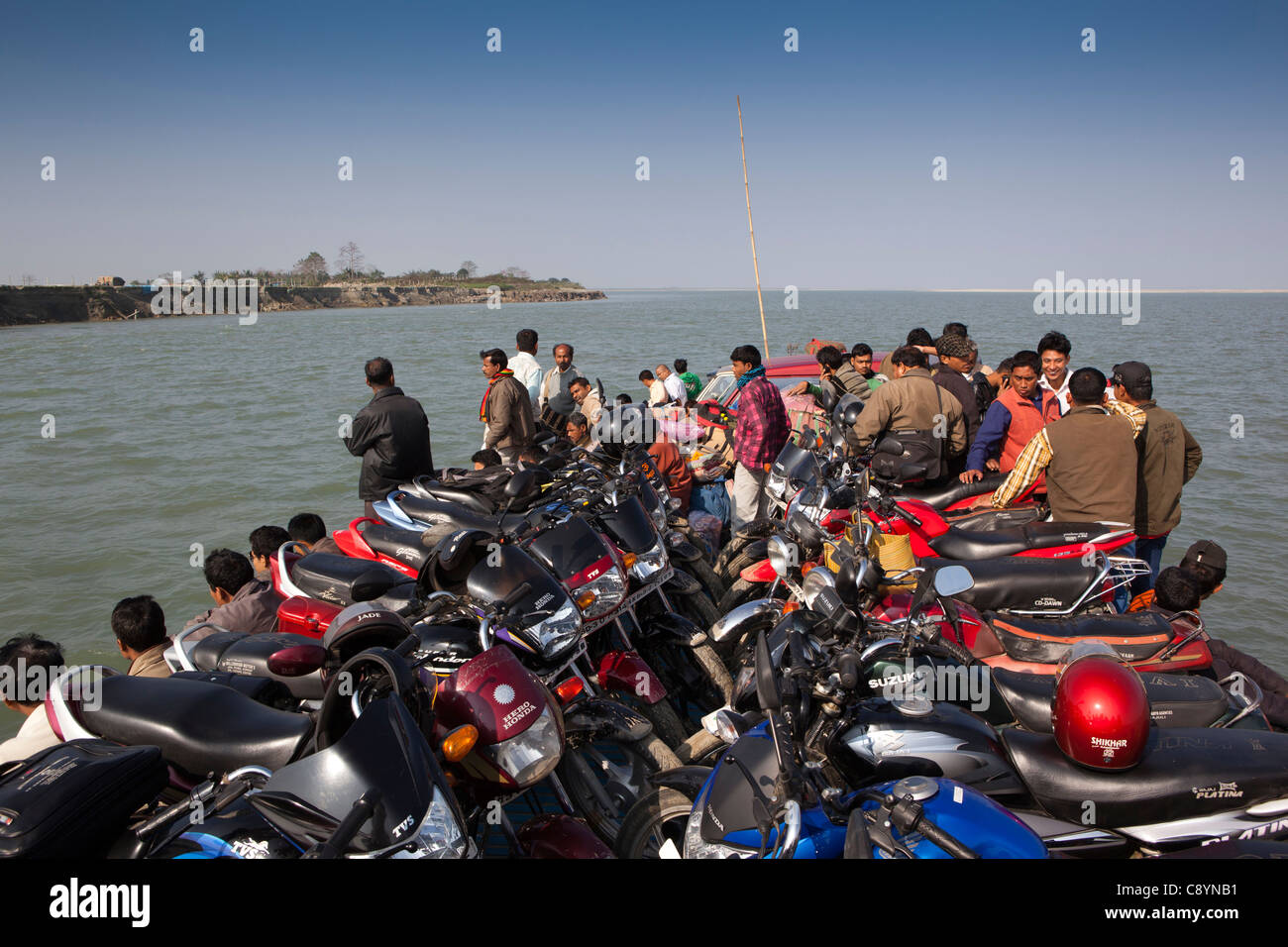 India, Assam, Jorhat, dangerously overloaded car and passenger ferry ...