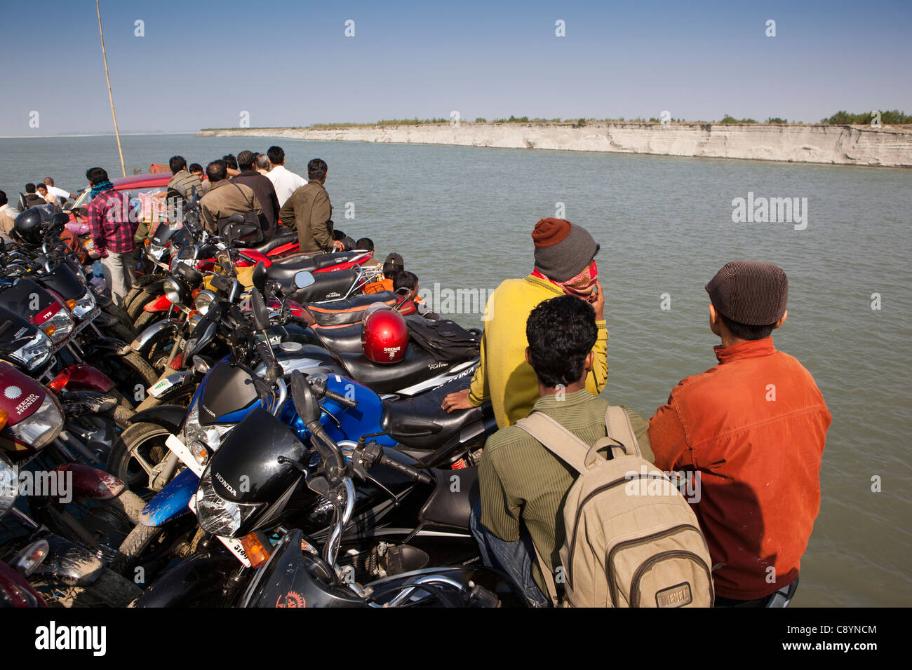 India, Assam, Jorhat, dangerously overloaded car and passenger ferry ...