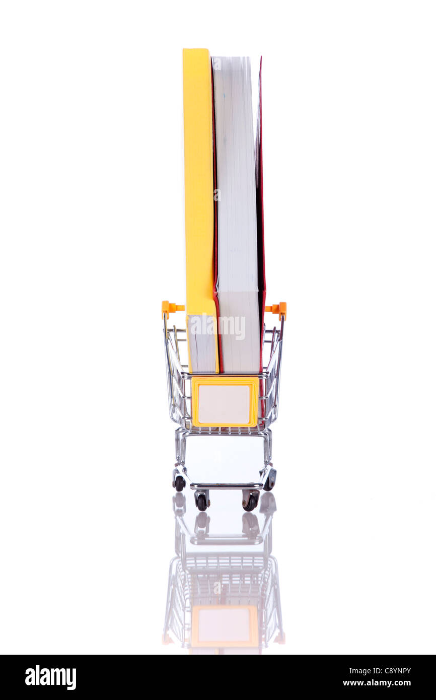 Stack of color books and a shopping cart (isolated on white Stock Photo ...