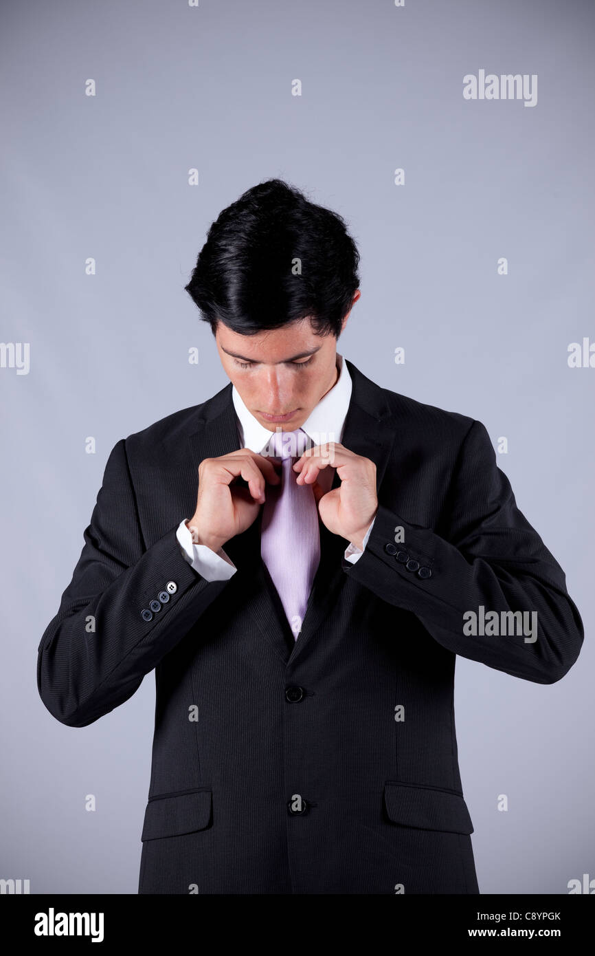 Portrait of a young businessman with a grey background Stock Photo - Alamy