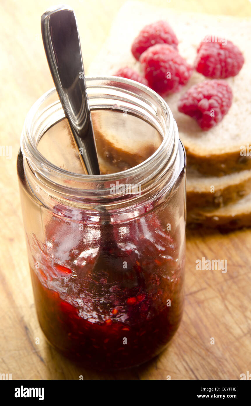 home made raspberry jam in a glass with a spoon Stock Photo - Alamy