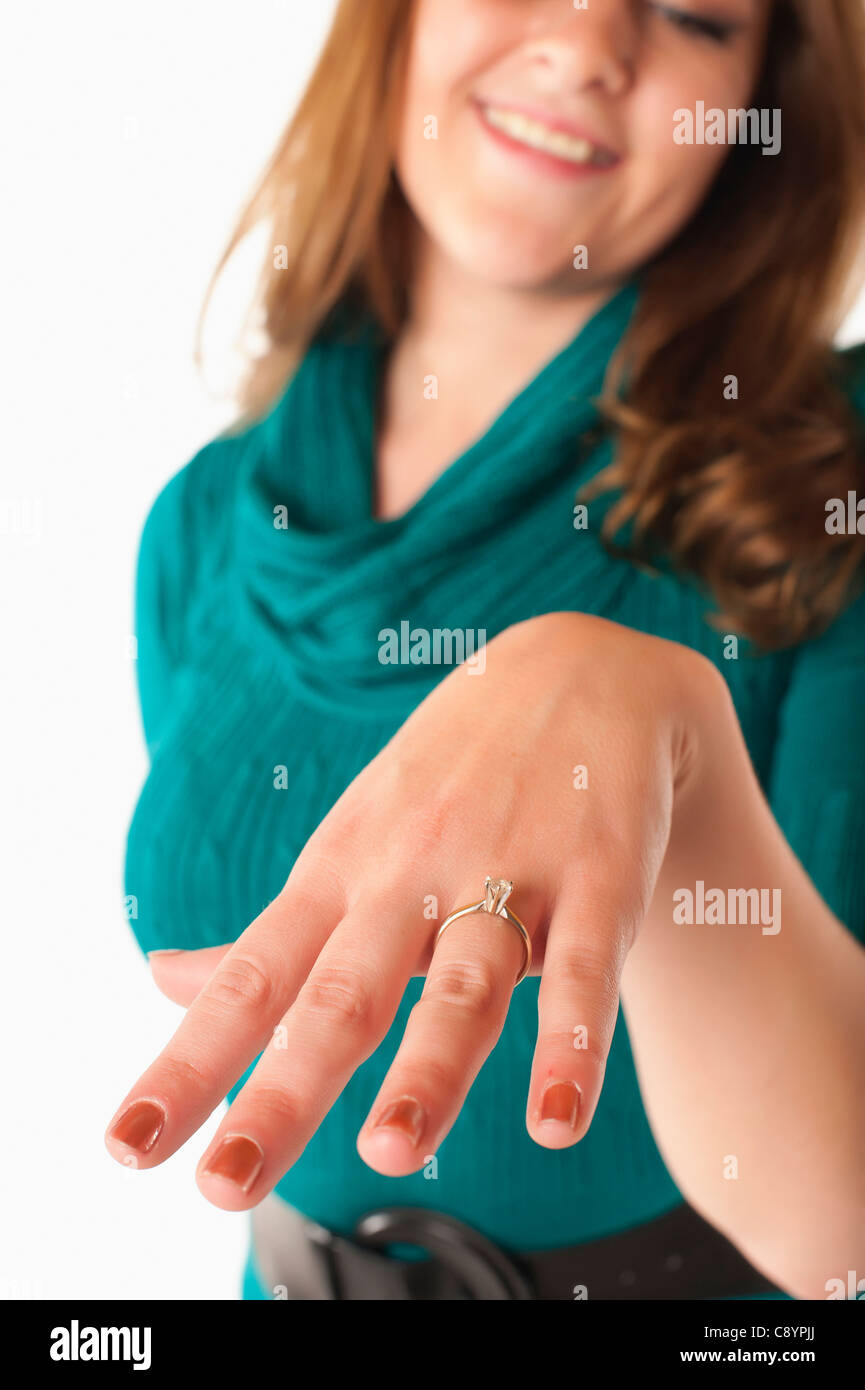 Happy woman looking at engagement ring Stock Photo - Alamy