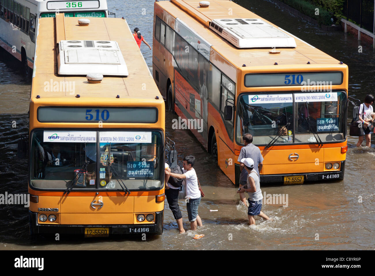Bus stops and passengers under flood water in Bangkok city centre ...