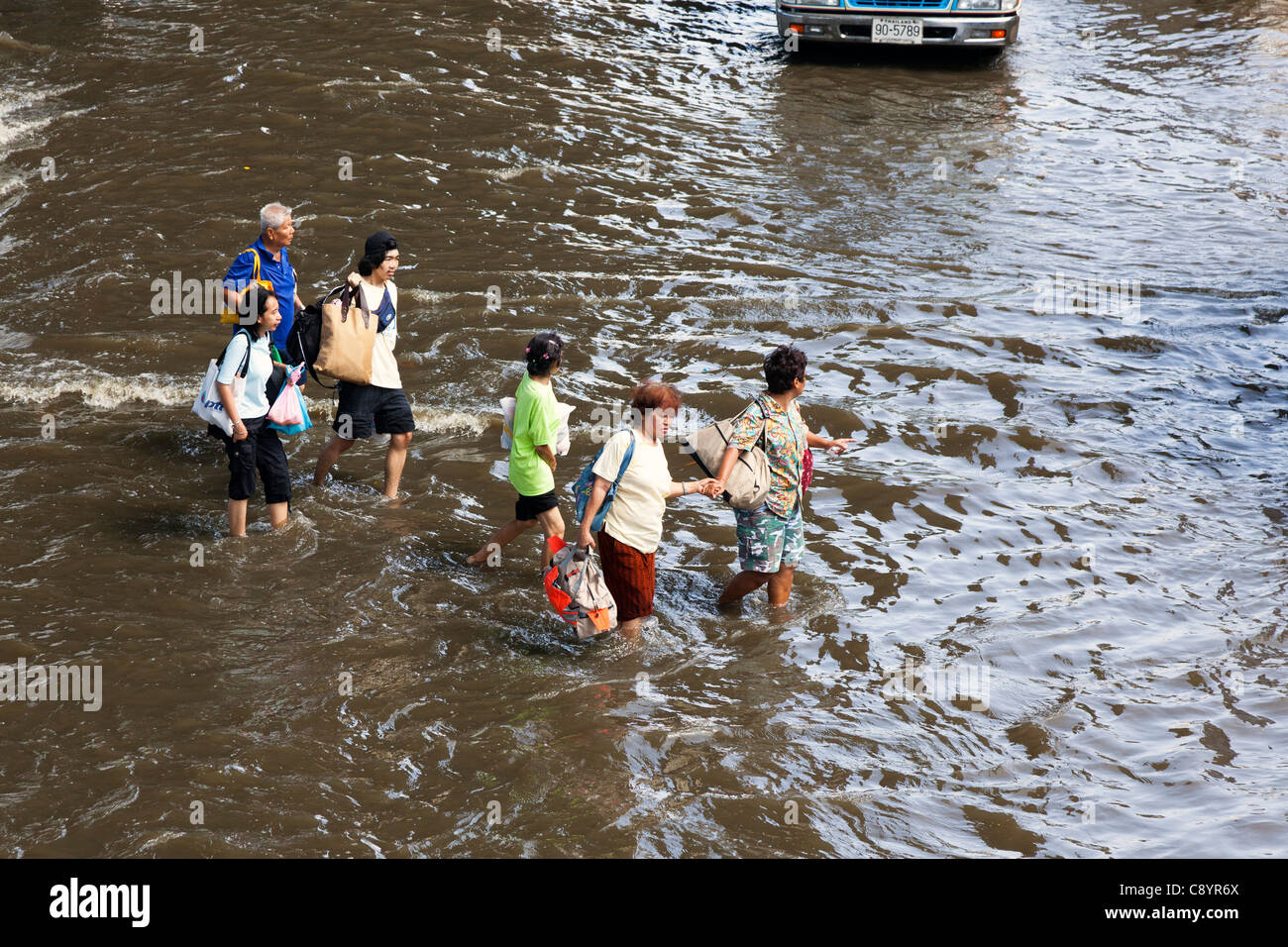 Refugees wading through flood water in Bangkok city centre, Thailand ...