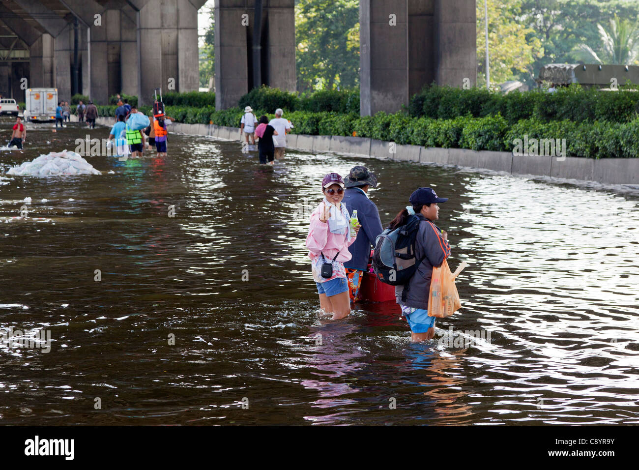 People walking through the flood water in Bangkok city centre, Thailand ...