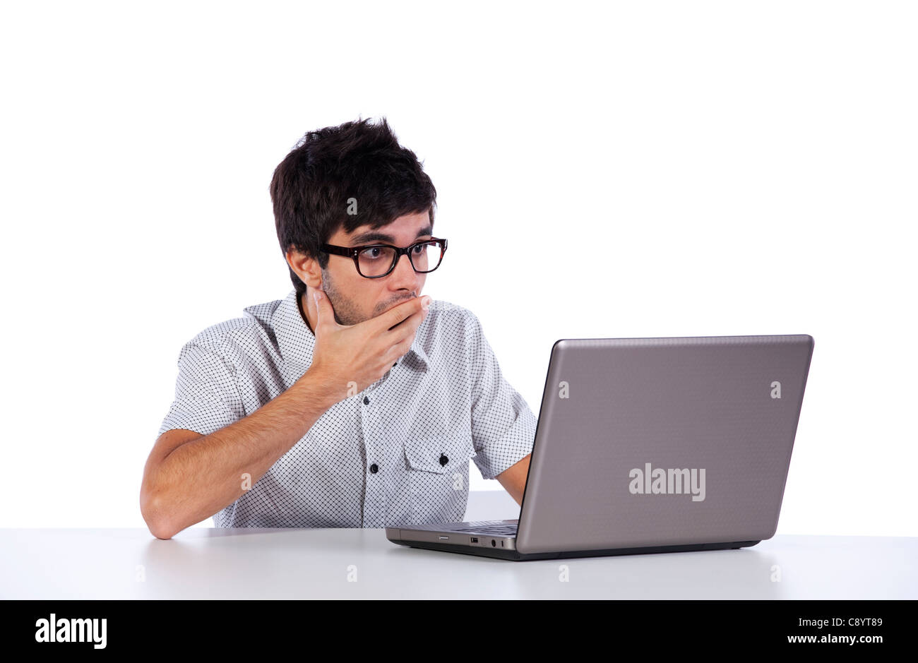 young man shocked with something he see on his laptop computer Stock ...