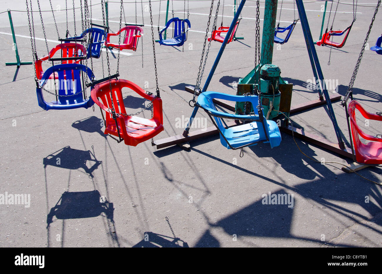 colorful and empty carousel chairs in the square Stock Photo - Alamy