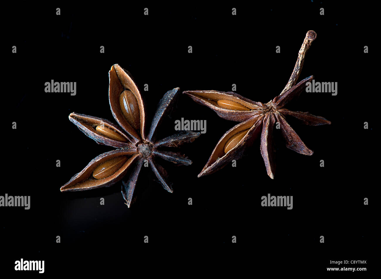 aerial view of two aniseed seeds on a black surface, color image Stock ...