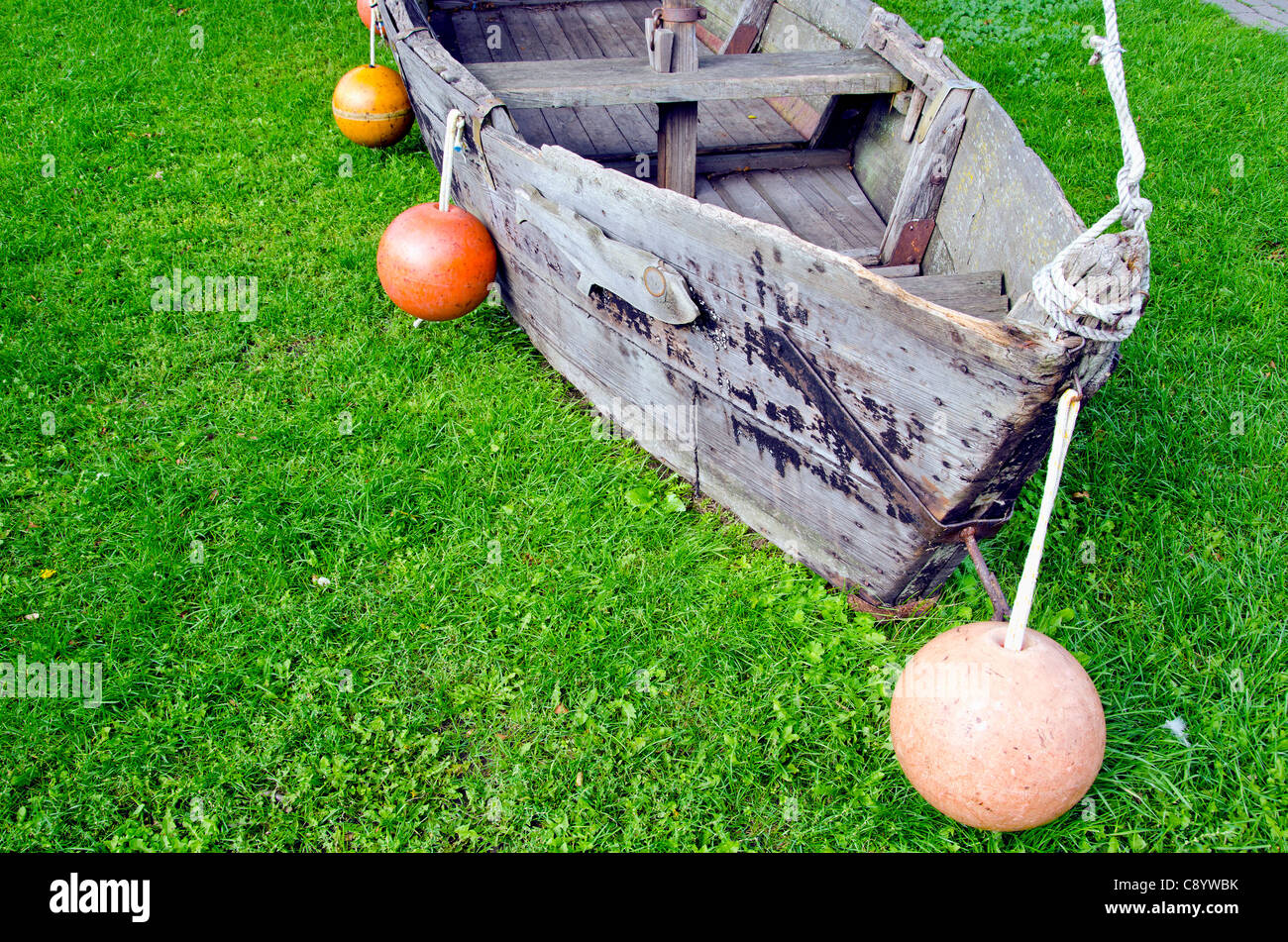 historical wooden fishermans boat on grass Stock Photo - Alamy
